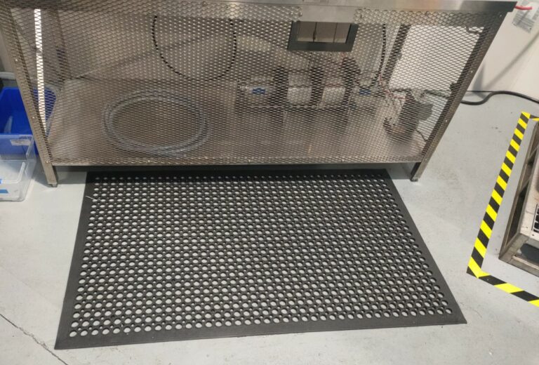 A really good rubber mat with anti-fatigue properties - with holes